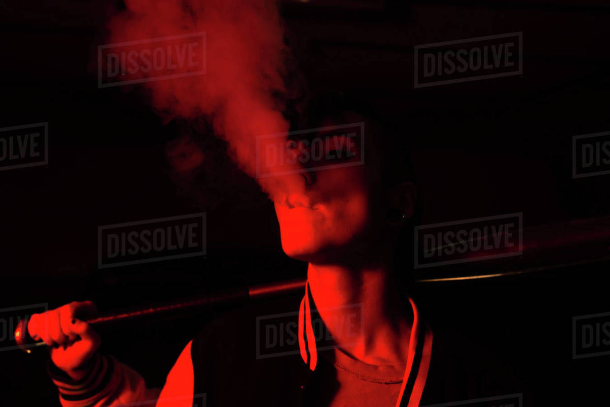 Contemporary female in bomber jacket holding a black baseball bat on ...