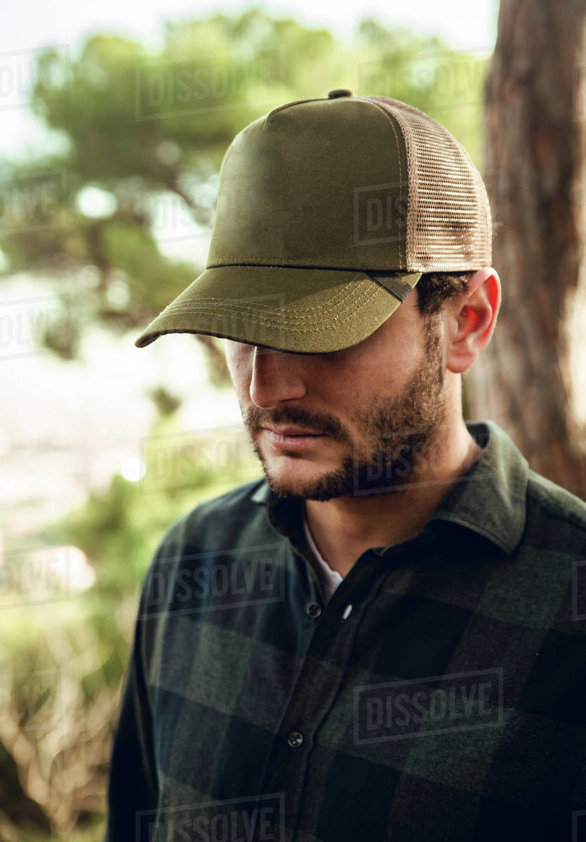 Unrecognizable portrait of brunet man in checkered shirt and baseball ...