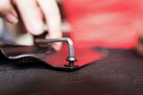 Cropped unrecognizable female hand turning screw while installing ...