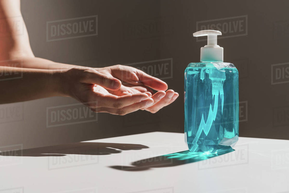 Flow of blue liquid soap coming out of dispenser - Stock Photo - Dissolve