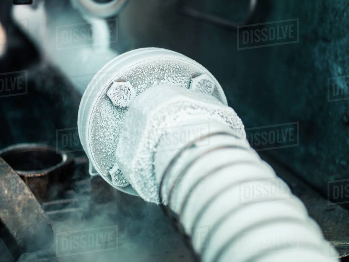 Closeup view of cooling pipe transferring liquid nitrogen surrounded by ...