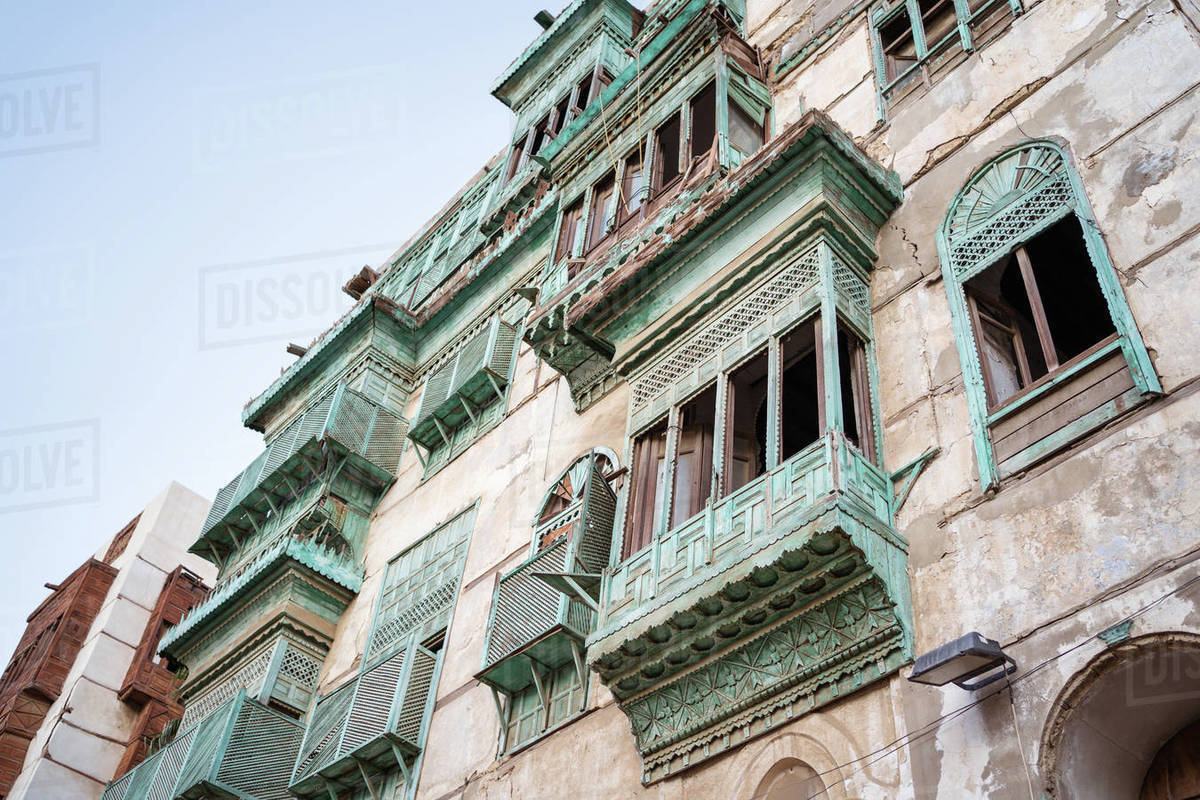Low angle of aged stone buildings with shabby walls and balconies on ...