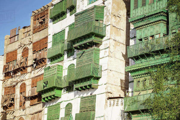 Low angle of aged stone buildings with shabby walls and balconies on ...
