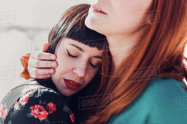 Side view of young sensual affectionate ladies in colorful trendy ...