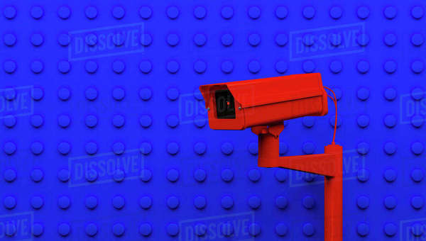 Red surveillance camera on blue background monitoring people on the ...