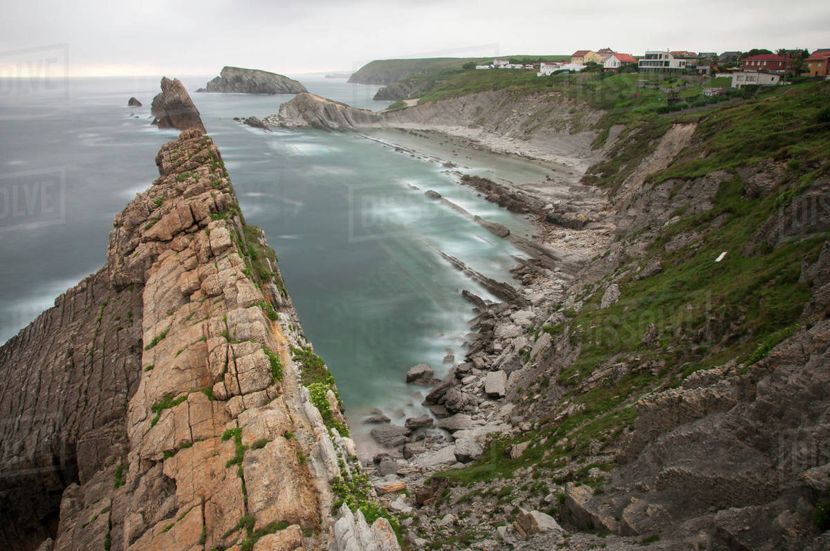 Rough rocky cliff on seashore - Stock Photo - Dissolve