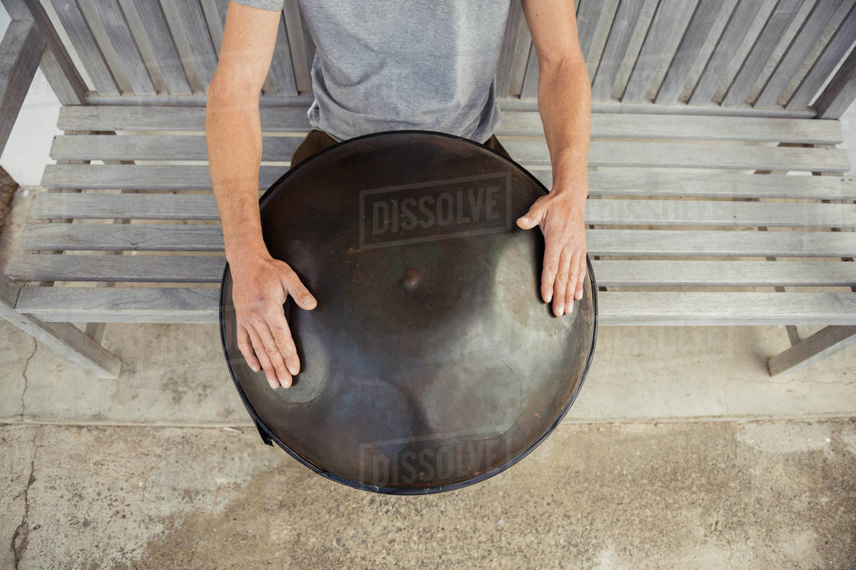Blond man sitting on bench with big hand drum - Royalty-free Stock ...