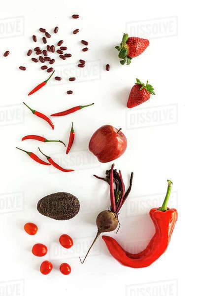 Mix of fruits and vegetables in red color on white background. Healthy ...
