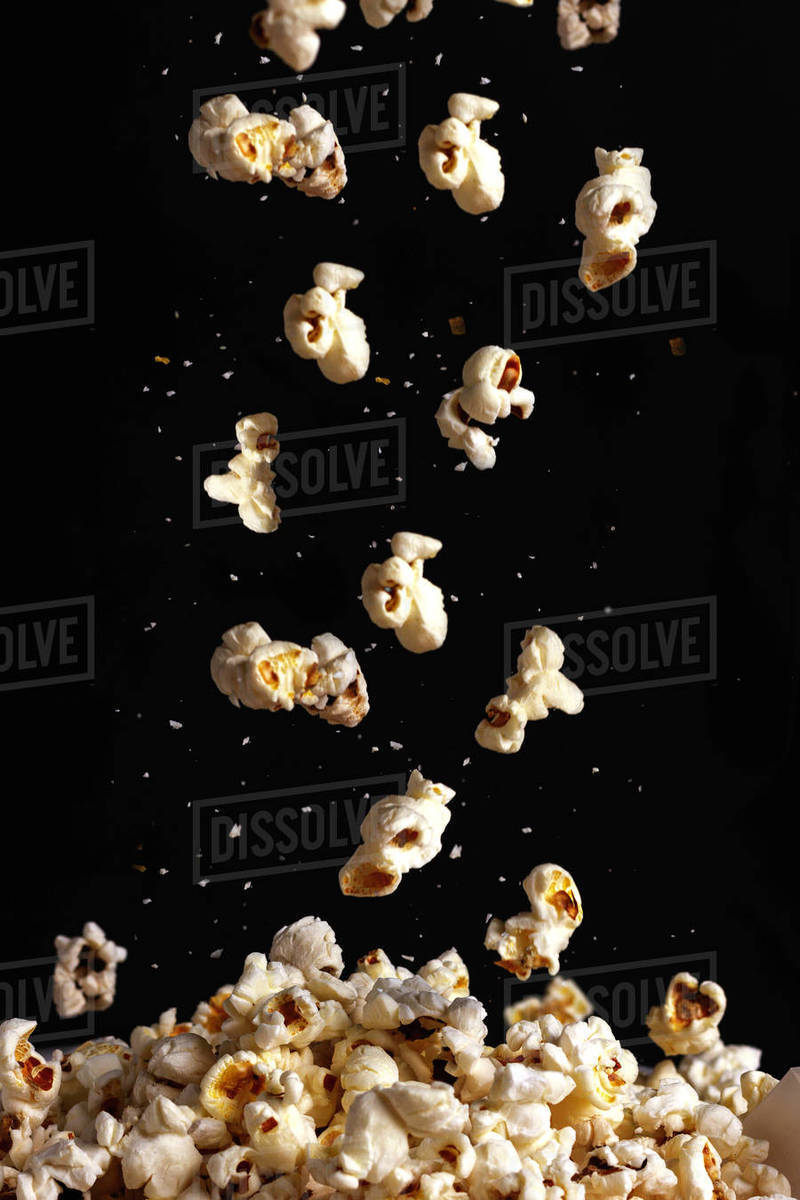 Popcorn falling down in black background - Royalty-free Stock Photo ...