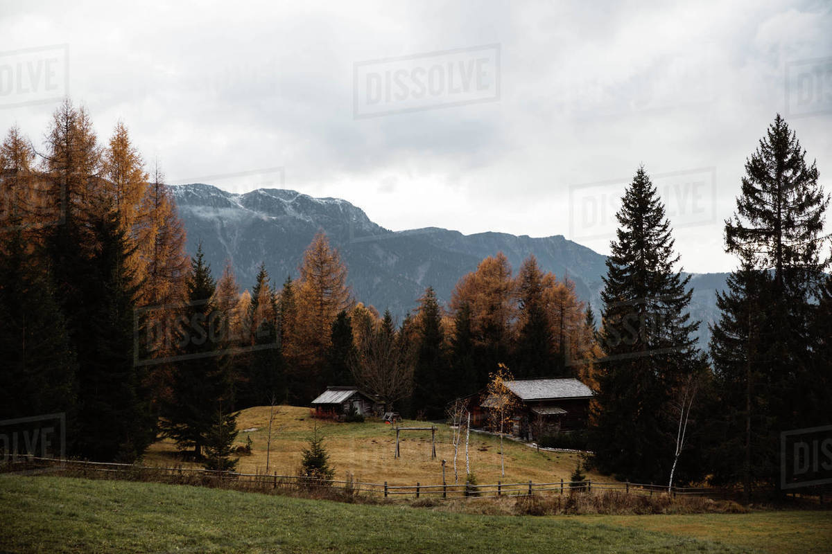 Picturesque view of building and trees in middle of valley by high ...