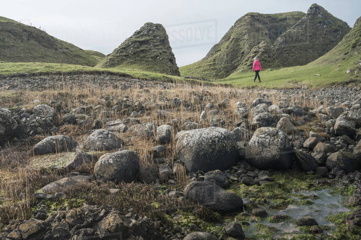 Anonymous woman enjoying amazing scenic landscape of Northern Ireland ...