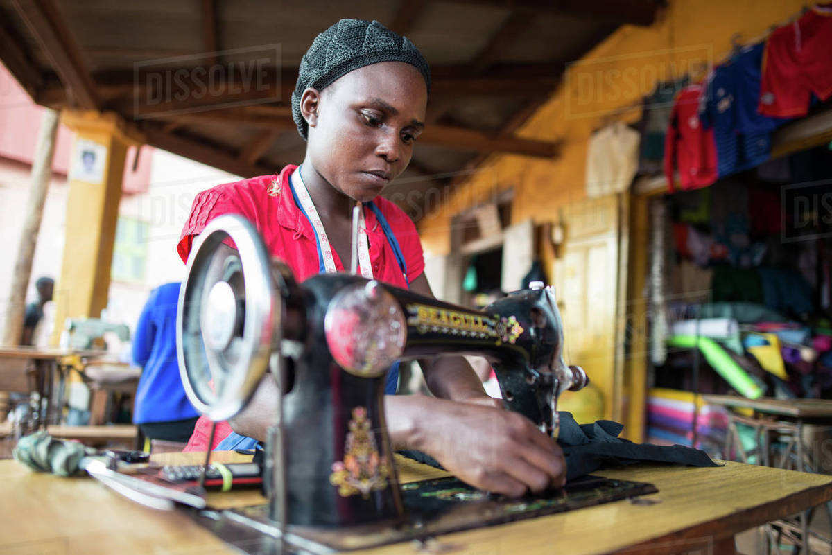 Uganda - November 26, 2016: Diligent African tailor woman in colorful ...