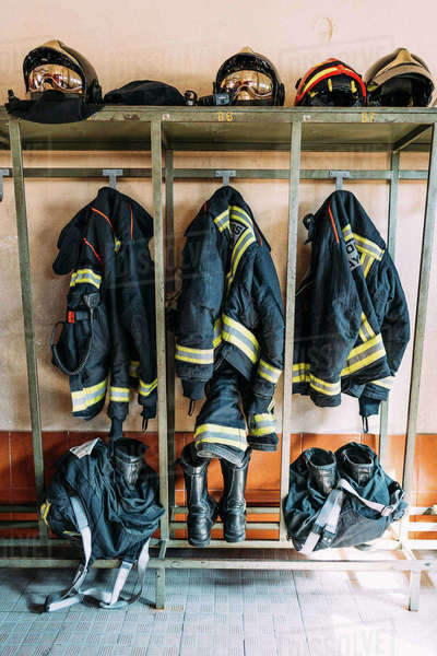 Used fireman uniforms representing heat resistant jackets and high ...