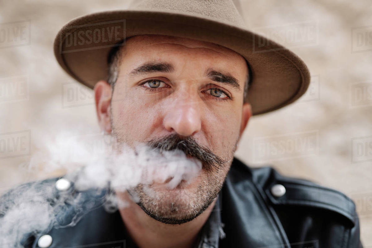 Cool handsome guy in with gorgeous mustache smoking cigarettes and ...