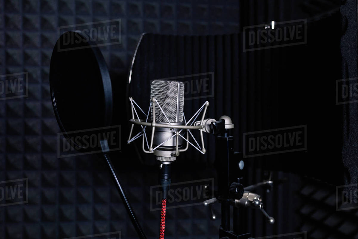 Contemporary metal microphone with wire placed on background of ...