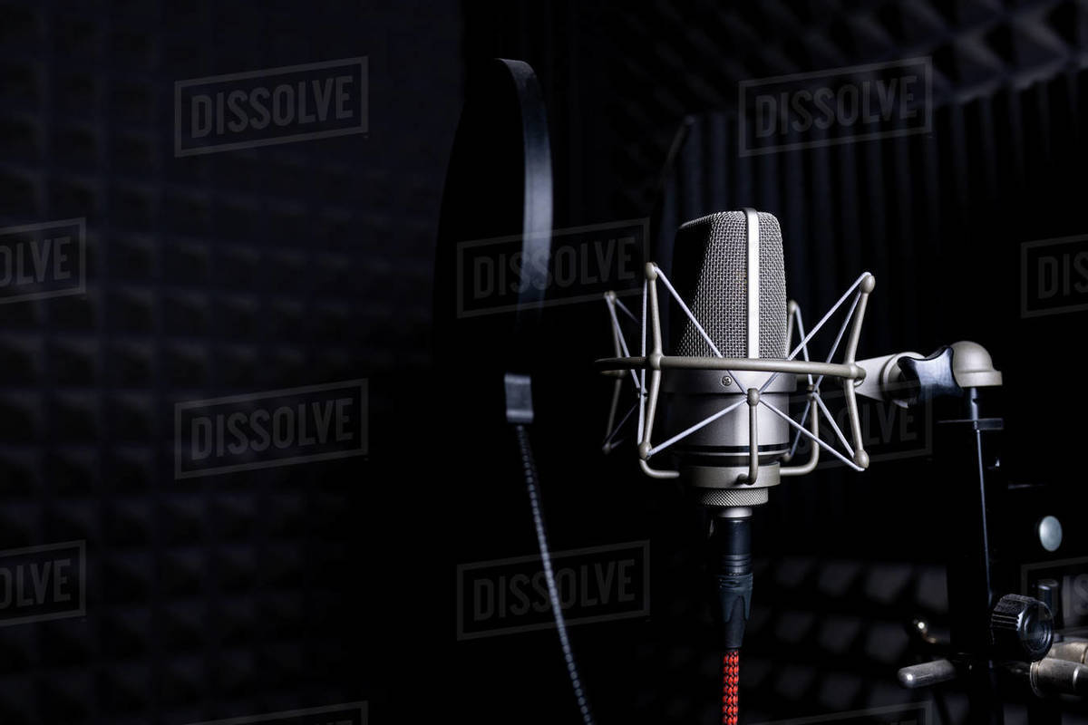 Contemporary metal microphone with wire placed on background of ...