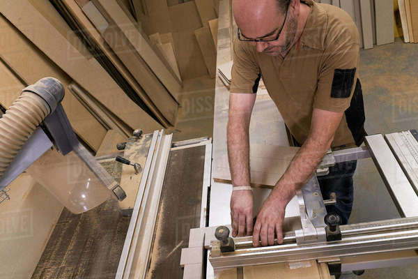 From above crop serious focused carpentry master in glasses and casual ...