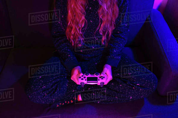 Front view of a blonde girl with a video game controller and colorful ...