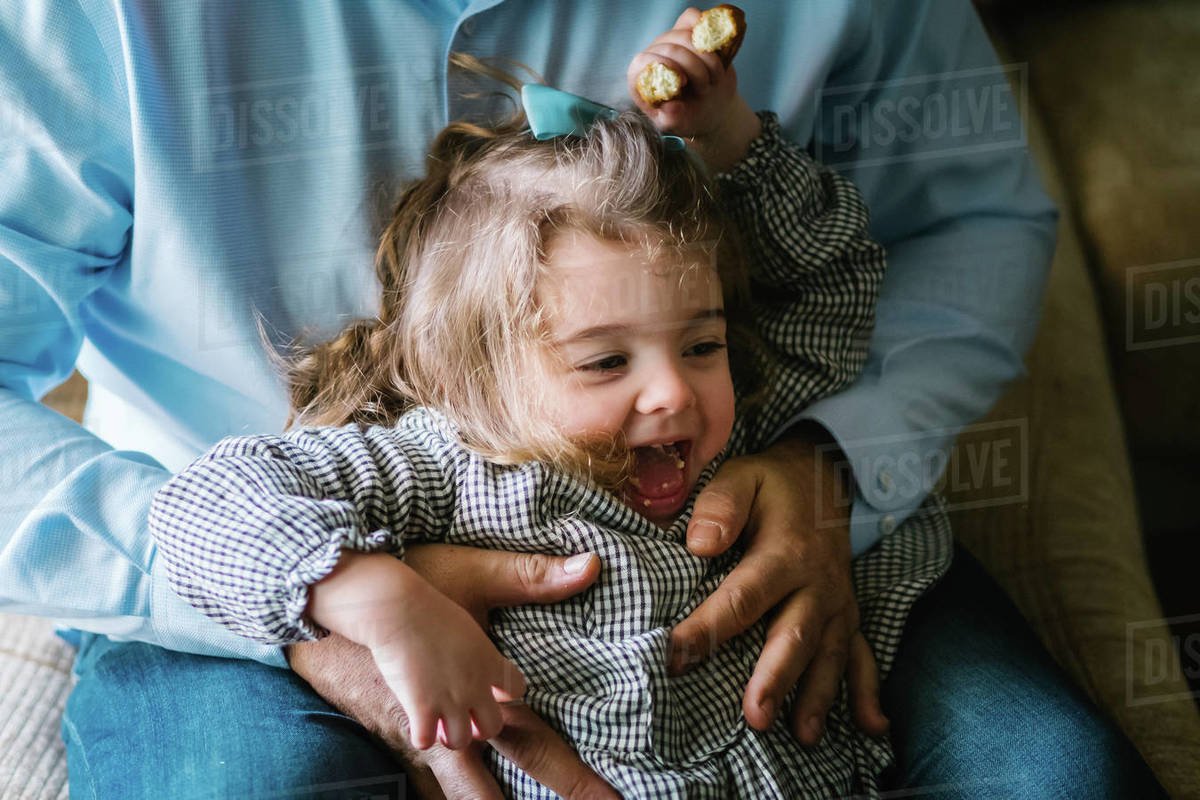 father hugging cute little girl looking away and having fun at home - Royalty-free Stock Photo ...