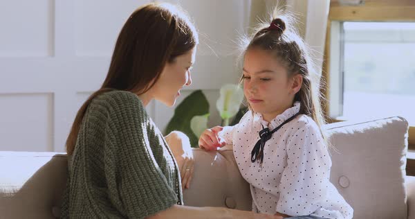 Caring mum talking with school child daughter sit on sofa - Stock Video ...