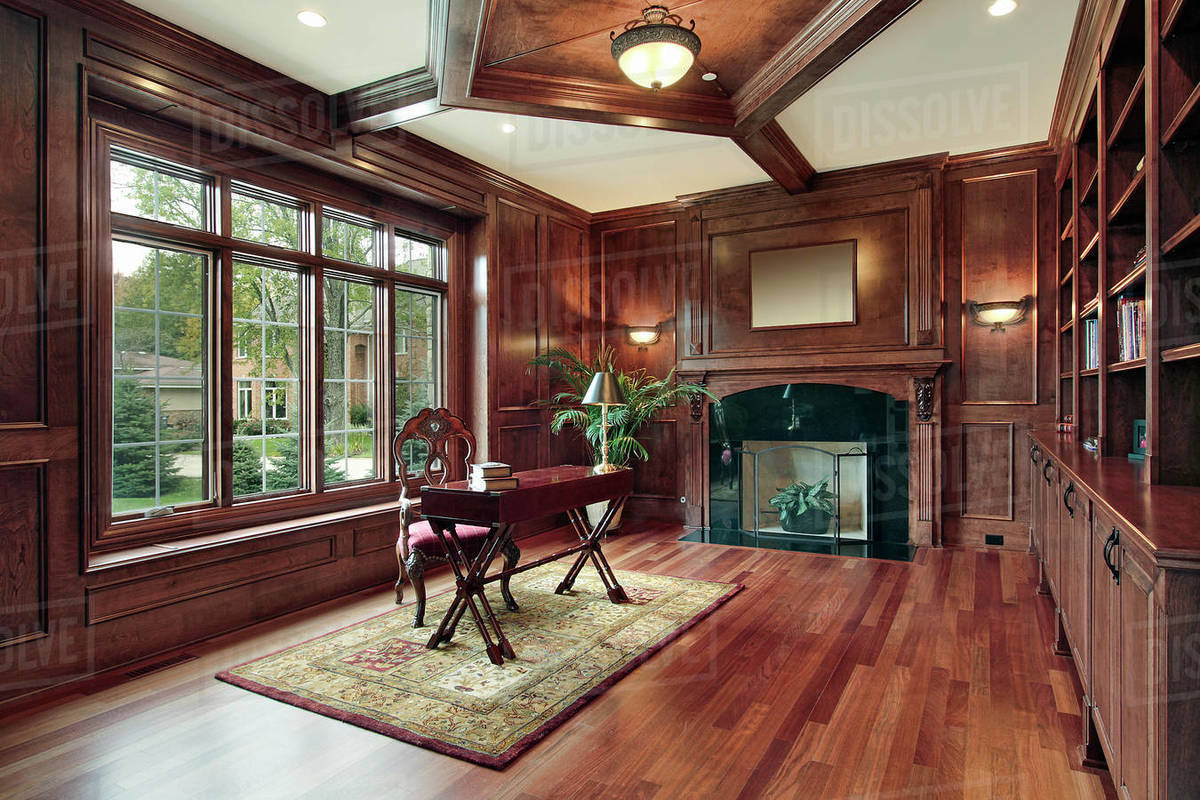 Elegant library in luxury home with black marble fireplace - Royalty ...