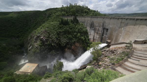 Slow motin general view of dam ejecting water at high pressure form ...