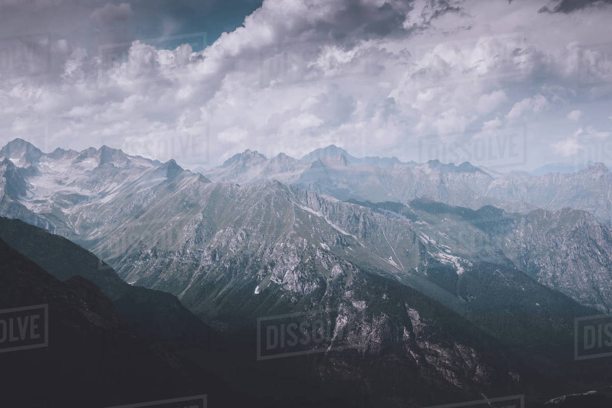 Mountains scene with dramatic cloudy sky in national park of Dombay ...