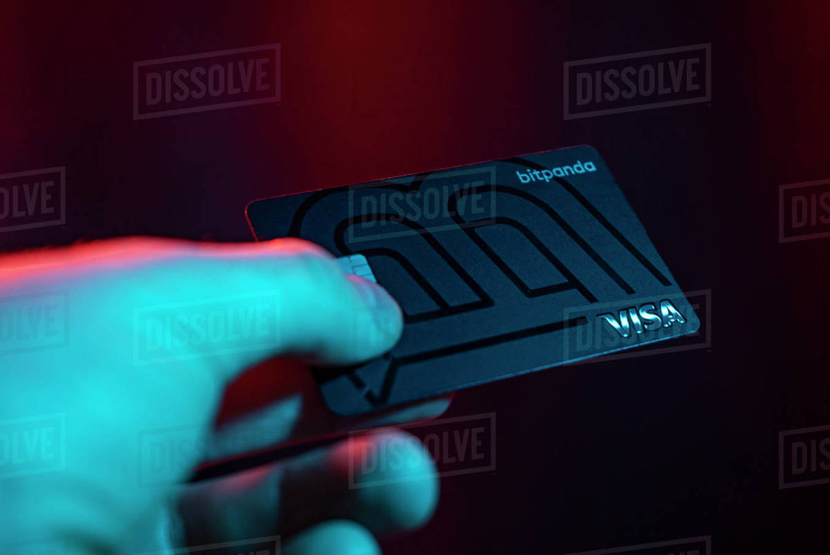 MILAN, ITALY 21 OCTOBER 2021: Credit Card in Hand detail in dark scene ...