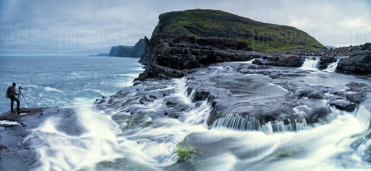 Panoramic of photographer at Bosdalafossur waterfall, Vagar island ...