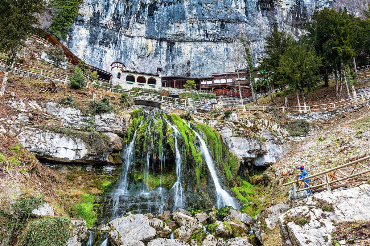 Tourist looking at St. Beatus Waterfall, Beatenberg, Canton of Bern ...