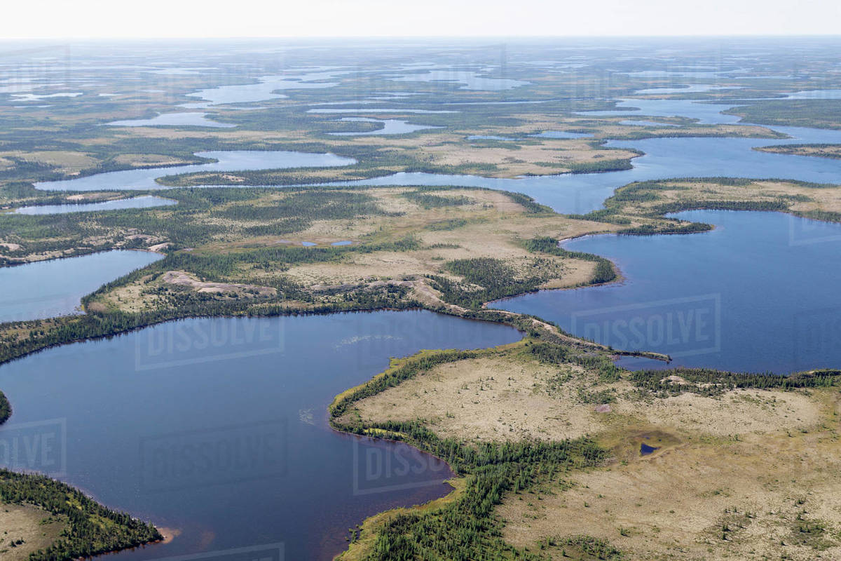 Aerial view of lakes and an esker, a ridge formed by sediment deposited ...