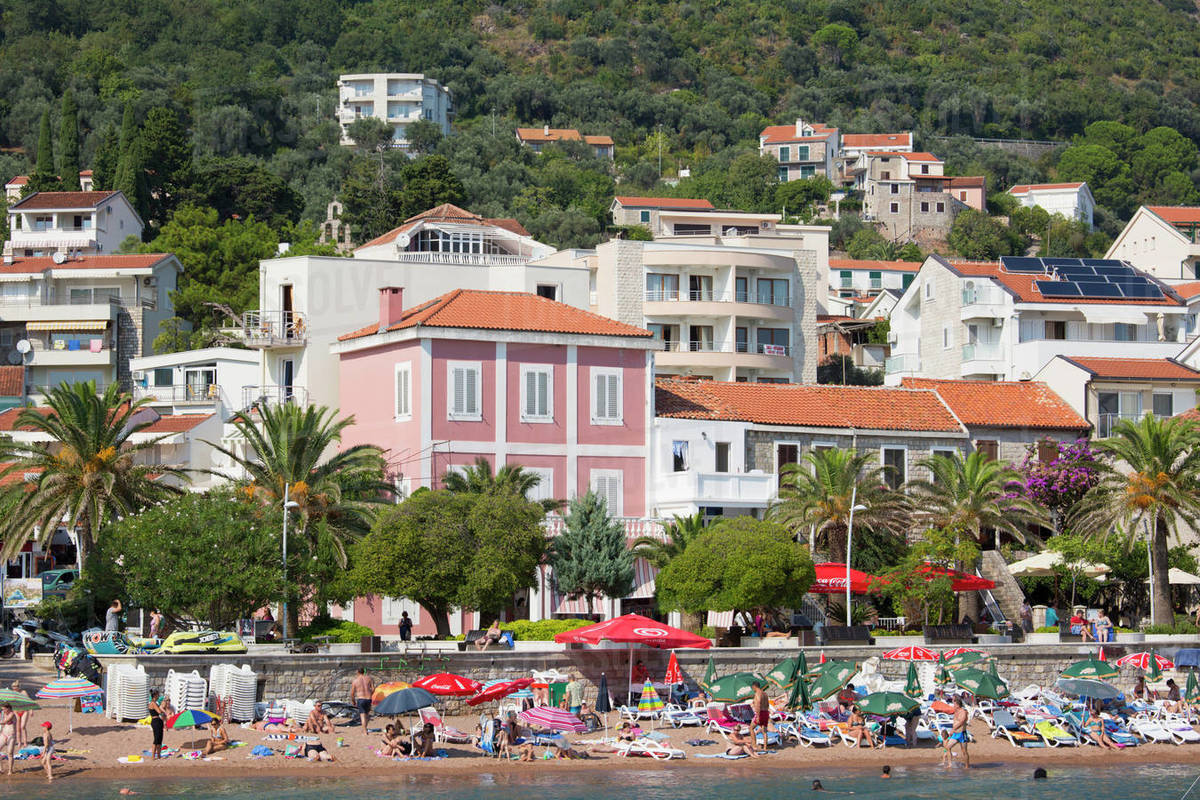 View to the town beach and colourful houses overlooking the palm-lined ...