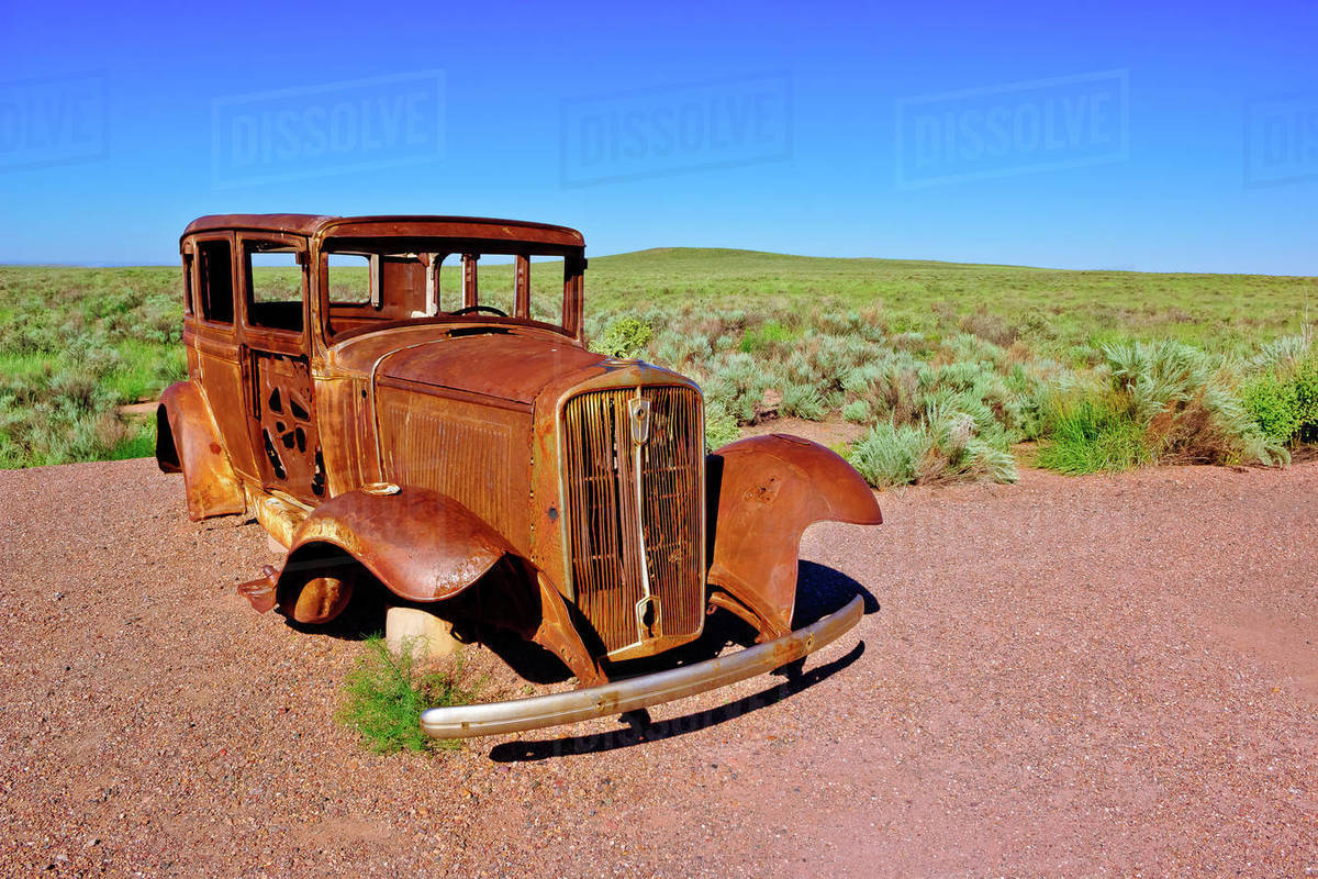 The old rusting steel shell of a Model-T mounted on concrete pillars ...