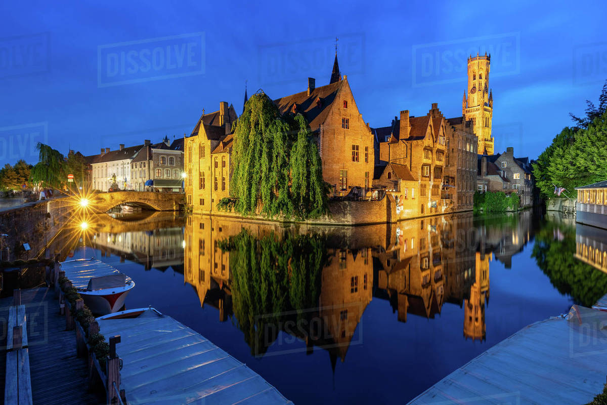 The beautiful buildings of Bruges reflected in the still waters of the ...