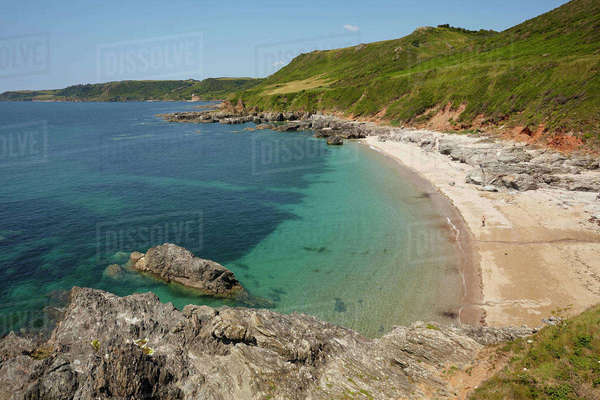 Classic Devon coastline, the rocks, beach and blue waters of ...