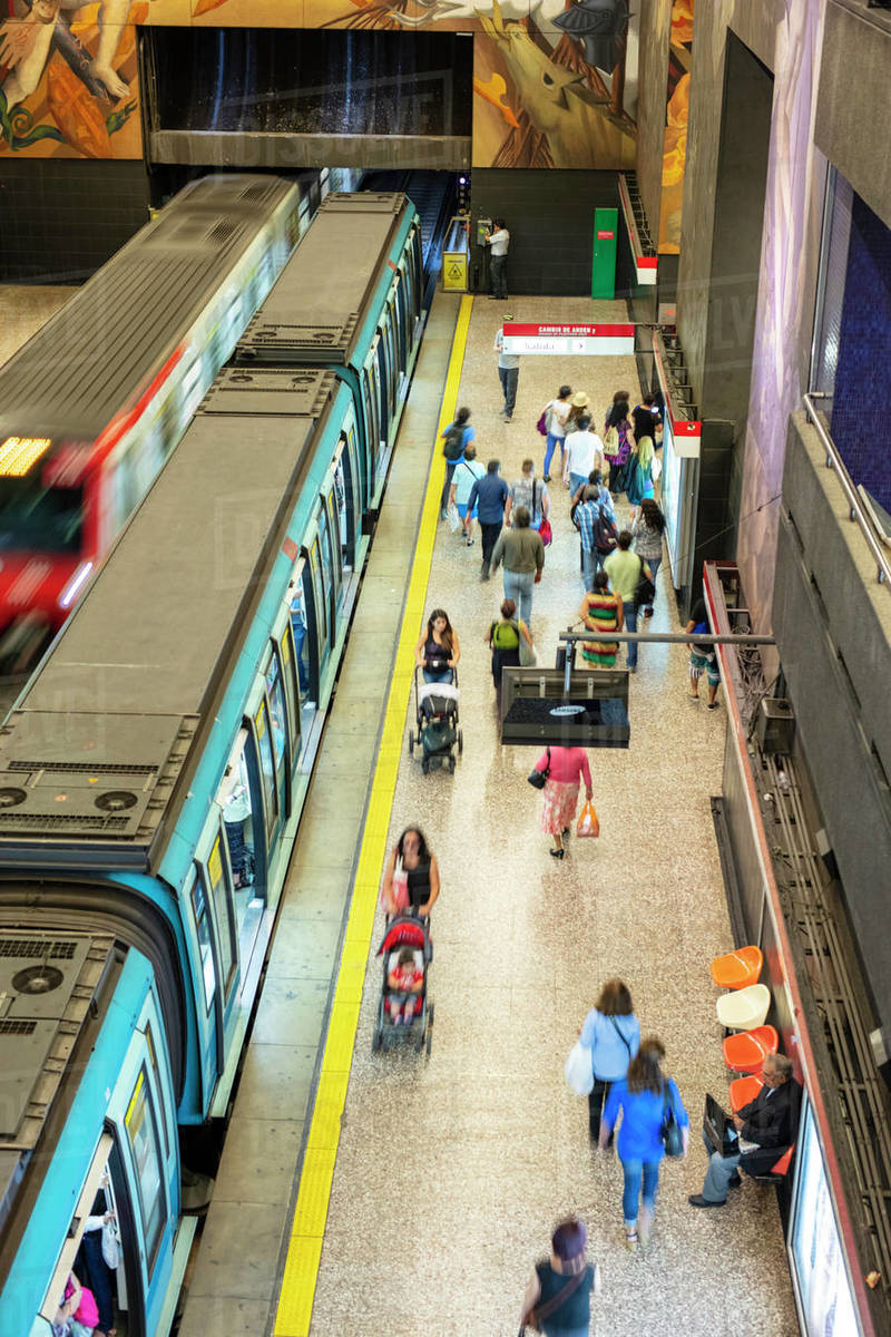 A subway station showing a train and commuter platform on the Metro de ...