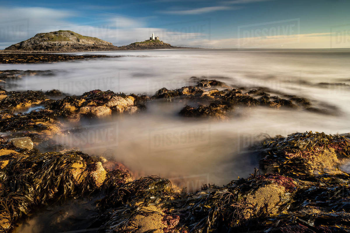 Tidal rock pools and Mumbles Lighthouse, Bracelet Bay, Mumbles Head ...