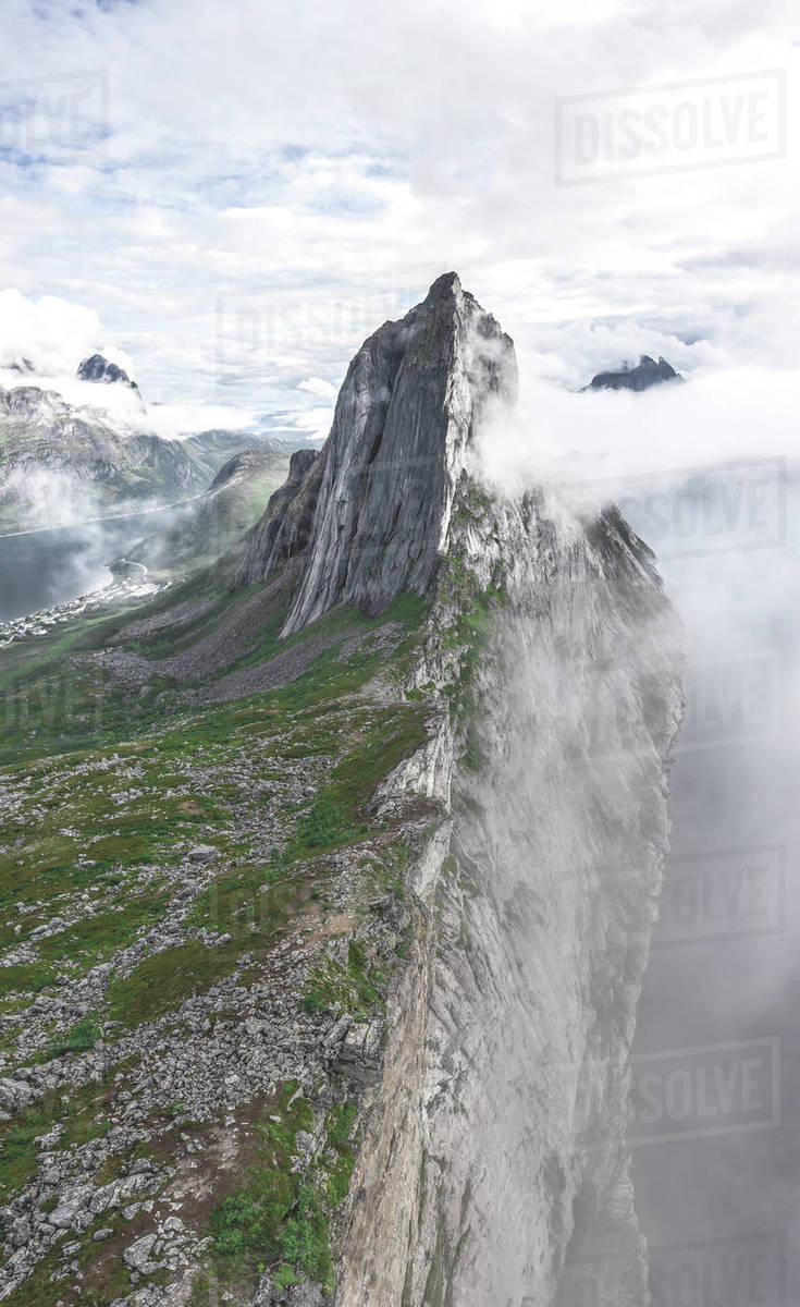 Aerial panoramic view of Mount Segla emerging from fog, Senja island ...