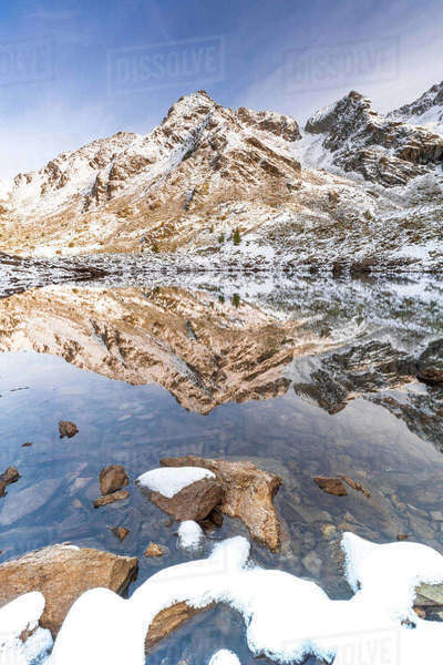 Corna Nera mountain peak reflected in Rogneda lake during the autumn ...
