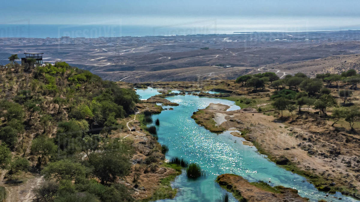 Aerial of a turquoise river in Wadi Darbat, Salalah, Oman, Middle East ...