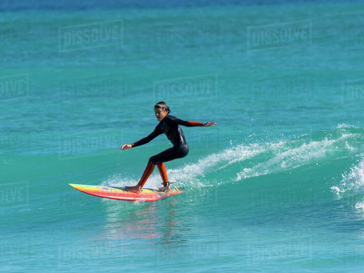 Surfer riding a wave at Ningaloo Reef, Western Australia, Australia ...