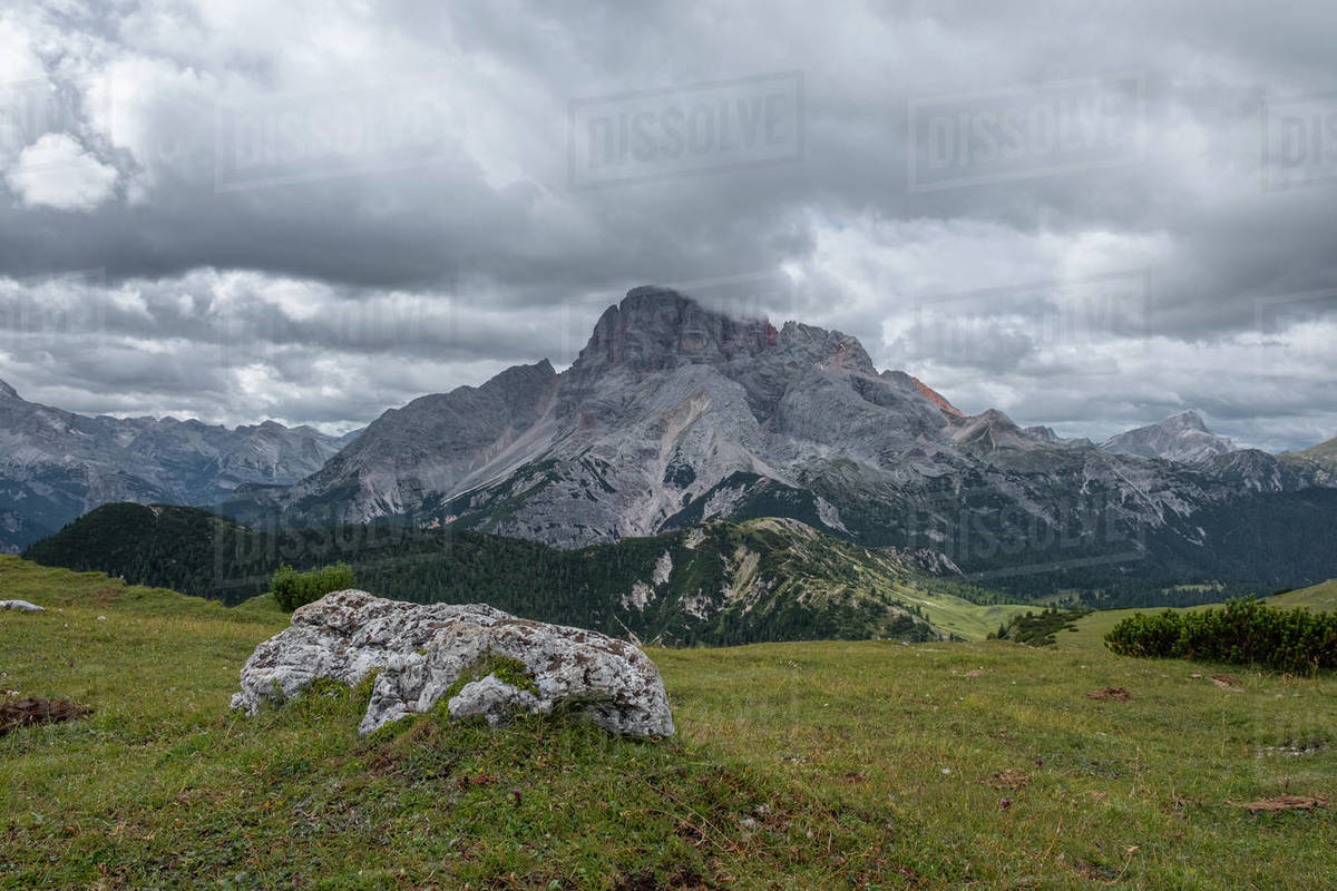 Panorama of the Croda Rossa D'ampezzo with pastures and a single rock ...