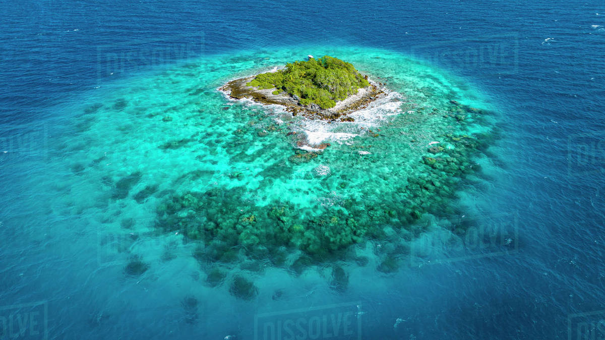Aerial of a small island in the lagoon of the Rangiroa atoll, Tuamotus ...