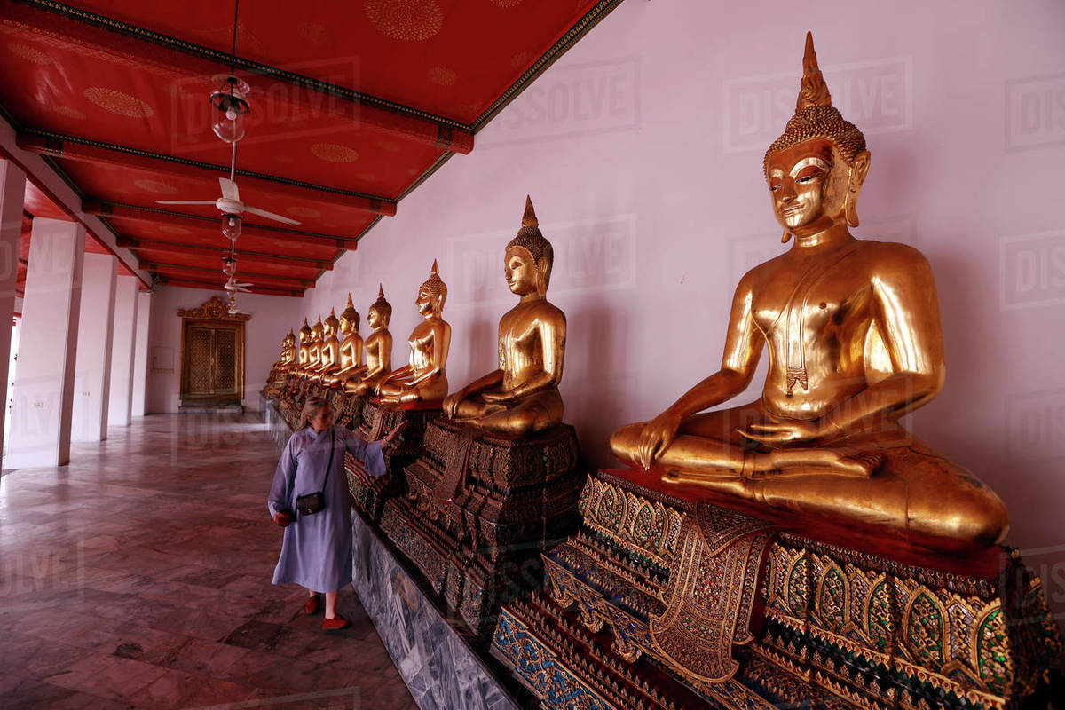 Row of golden Buddha statues, earth witness gesture, Wat Pho (Temple of ...