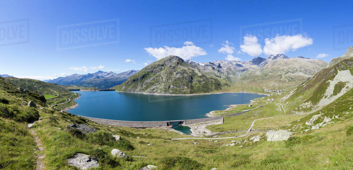 Panorama of the blue Lake Montespluga surrounded by rocky peaks in ...