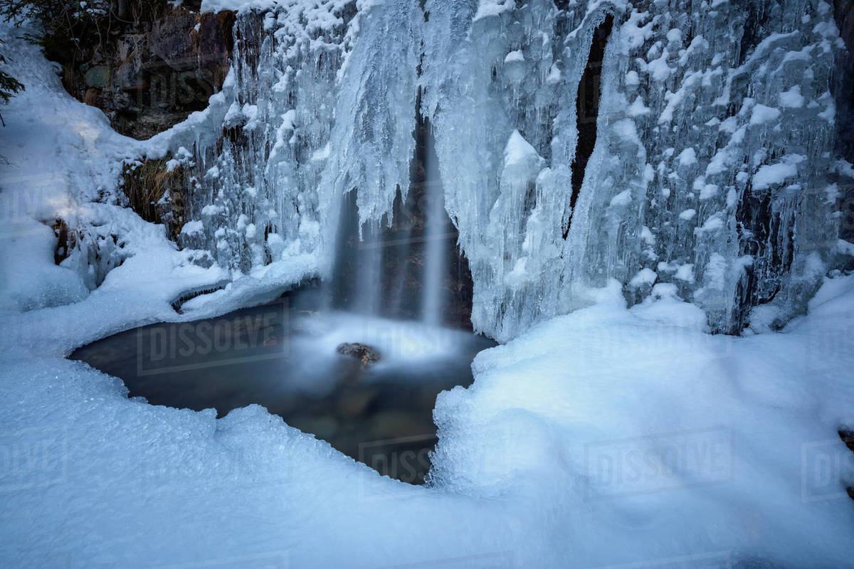 Details of a waterfall framed by ice and snow, Switzerland, Europe ...
