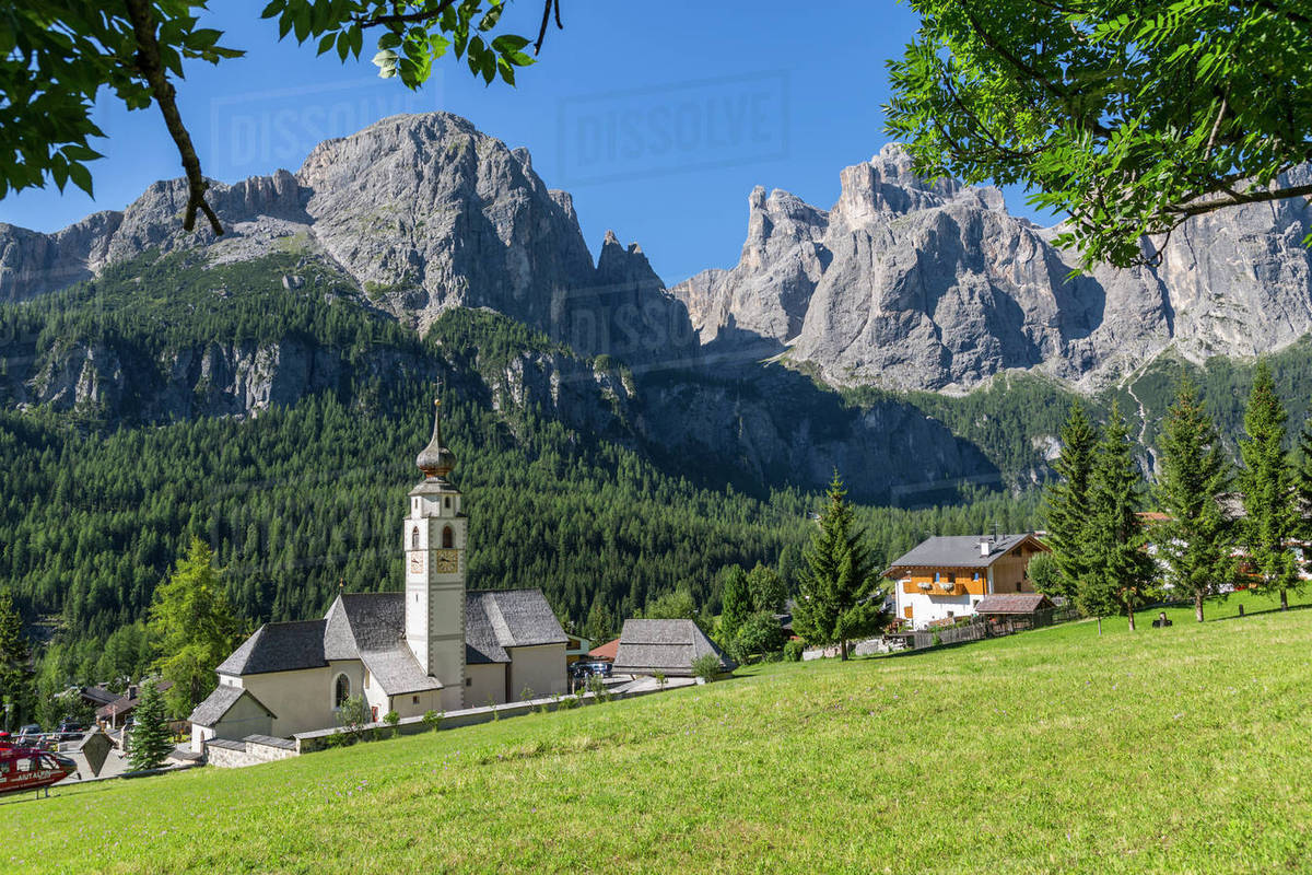 Morning view of Colfosco (Calfosch) Church and surrounding mountains ...