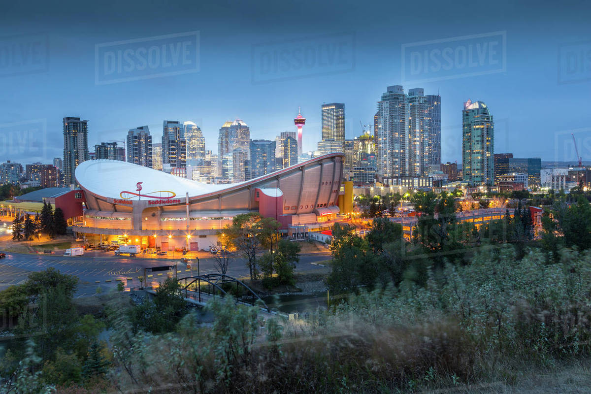 View of the Saddledome and Downtown skyline from Scottsman Hill at dusk ...