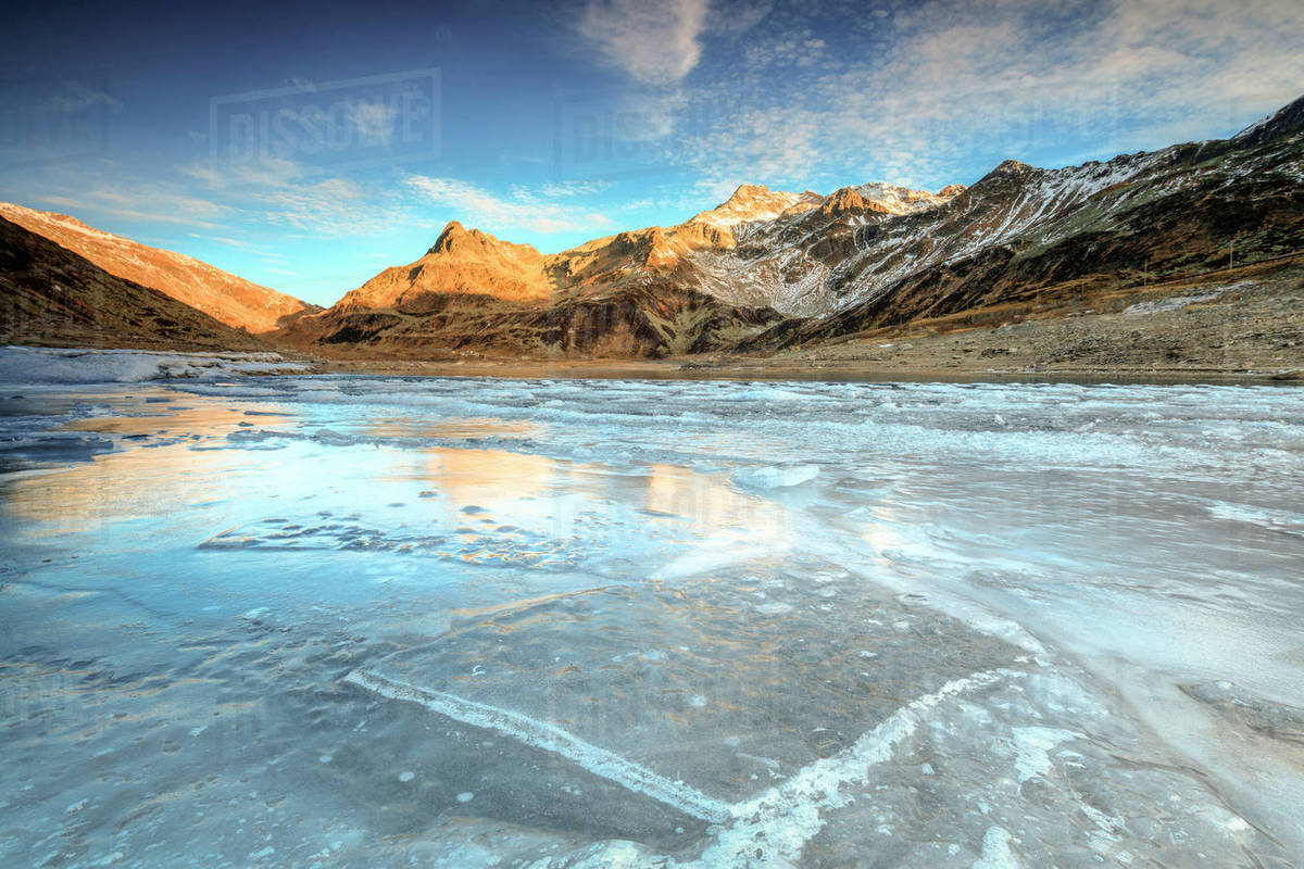 Frozen lake Montespluga at dawn, Chiavenna Valley, Sondrio province ...