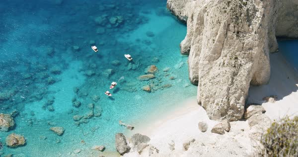 Top down view of hidden cute beaches with blue sea lagoons and tourist ...